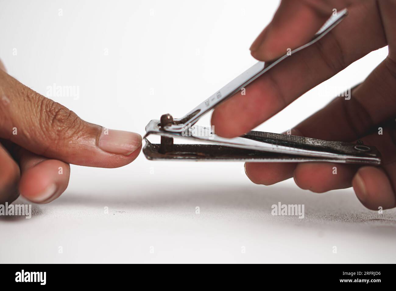 beautiful woman cut fingernail with herself Stock Photo - Alamy