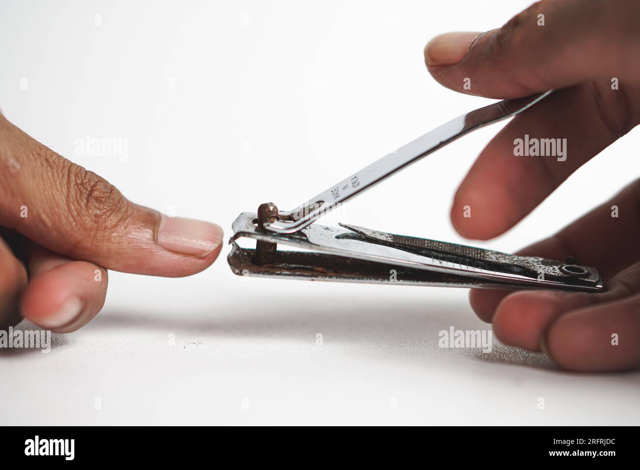 beautiful woman cut fingernail with herself Stock Photo - Alamy