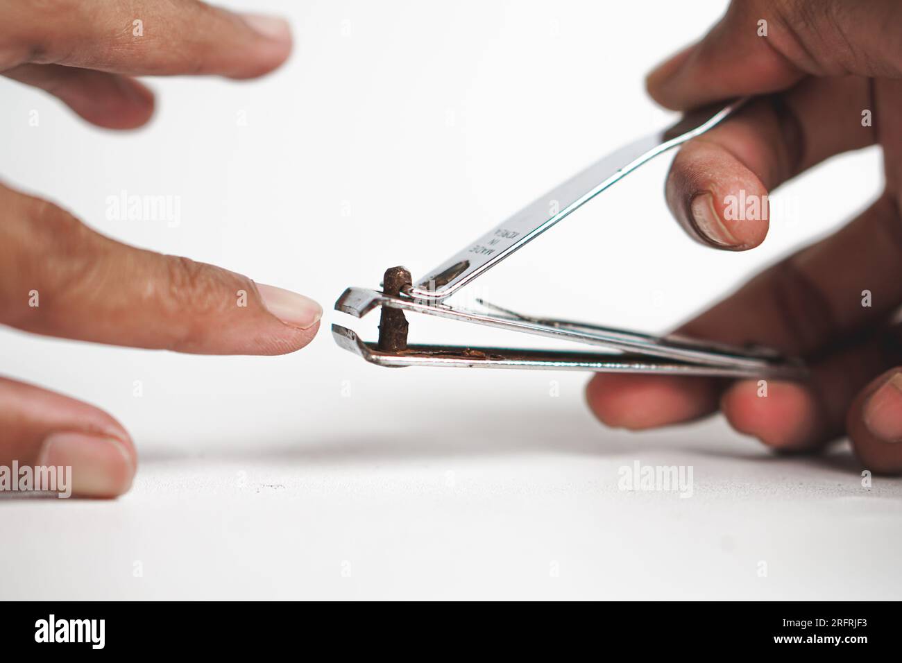 beautiful woman cut fingernail with herself Stock Photo - Alamy