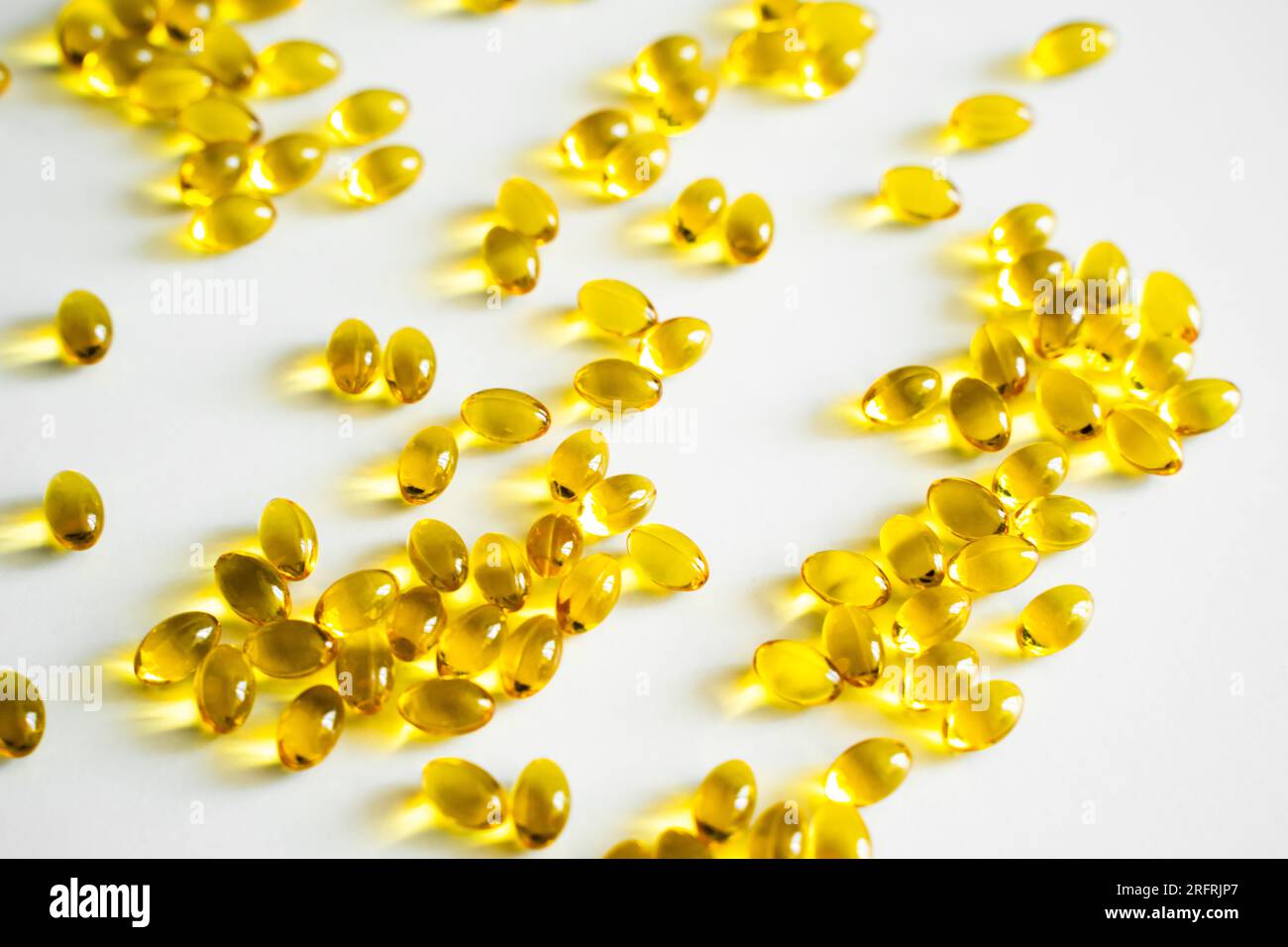 Oil filled capsules, softgel of food supplements. Vitamin D3. Yellow ...