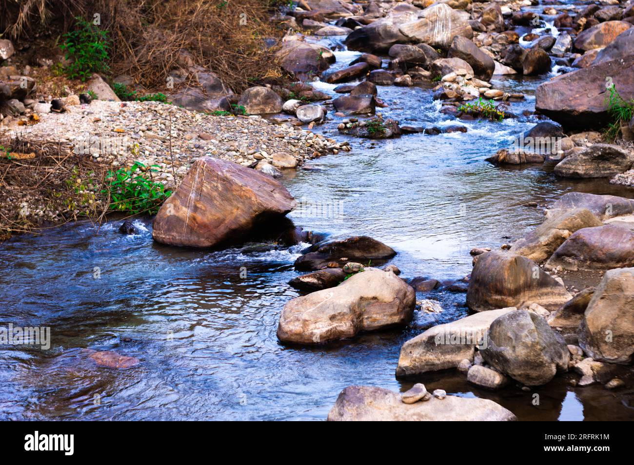 A small river creak flowing from Mountain Valley in a narrow winding ...