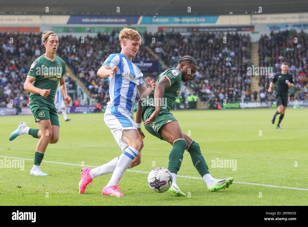 Bali Mumba #2 of Plymouth Argyle tackles Jack Rudoni #8 of Huddersfield Town during the Sky Bet ...