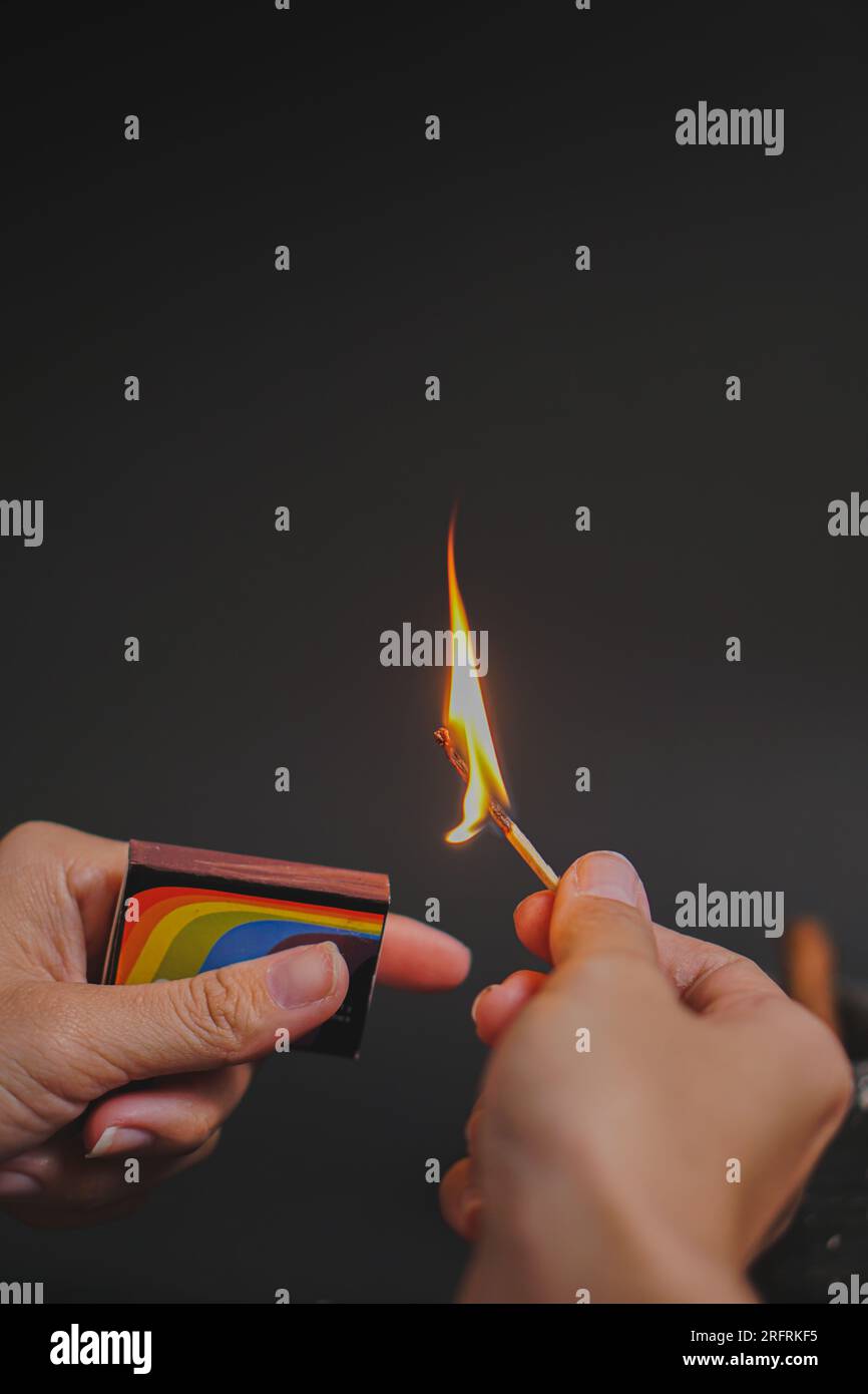 Burning lighting matches at the moment when it explodes over black ...