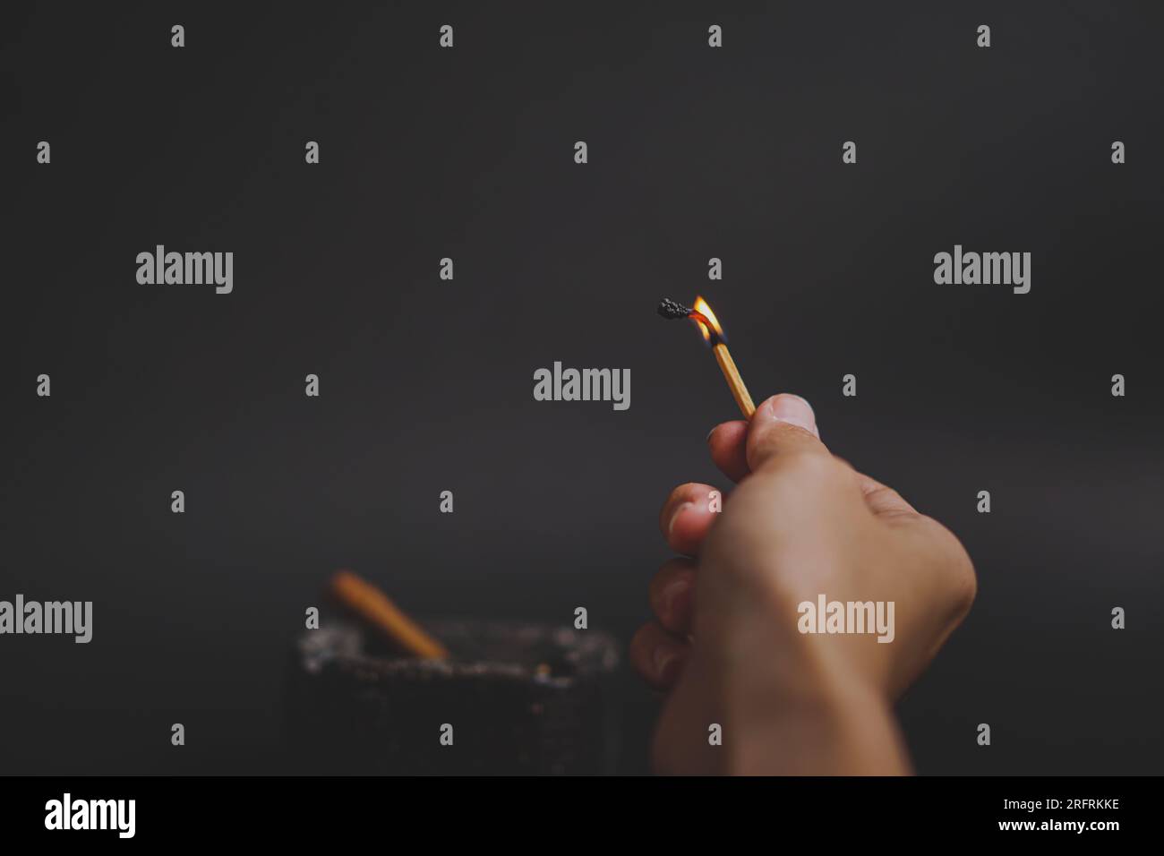 Burning lighting matches at the moment when it explodes over black ...
