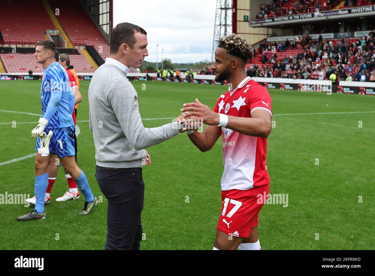 Neill Collins Head coach of Barnsley shakes hand with Barry Cotter #17 ...