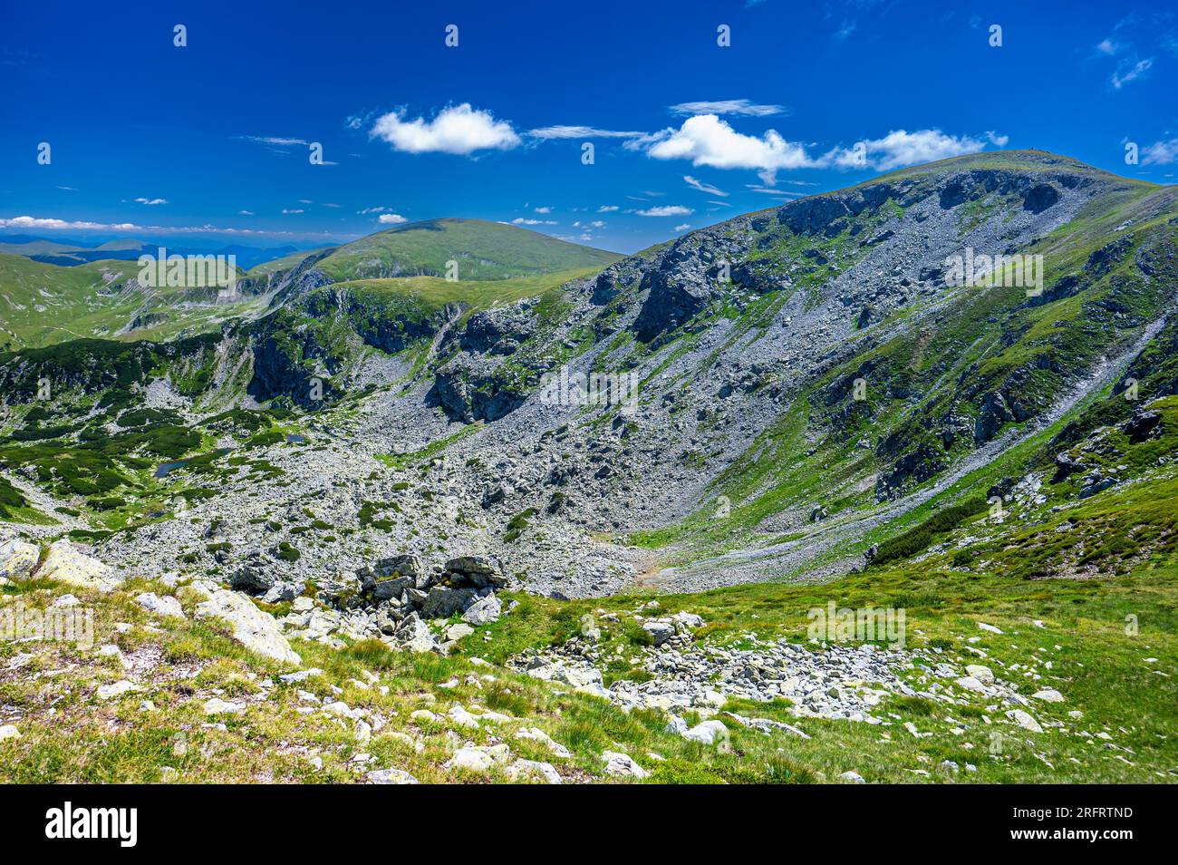 Summer day mountain landscape. Green rocky mountains and a blue sky ...