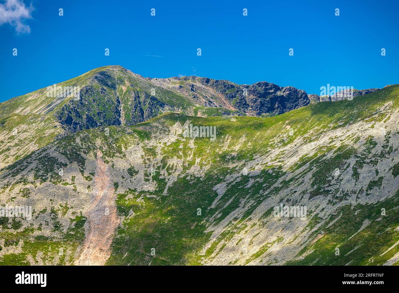 Summer day mountain landscape. Green rocky mountains and a blue sky ...