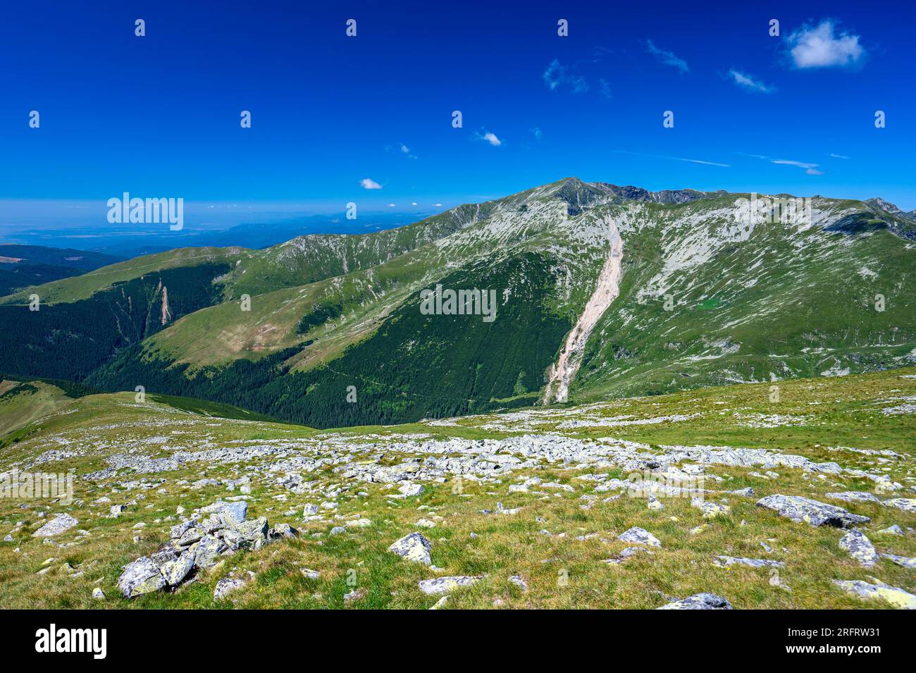 Summer day mountain landscape. Green rocky mountains and a blue sky ...