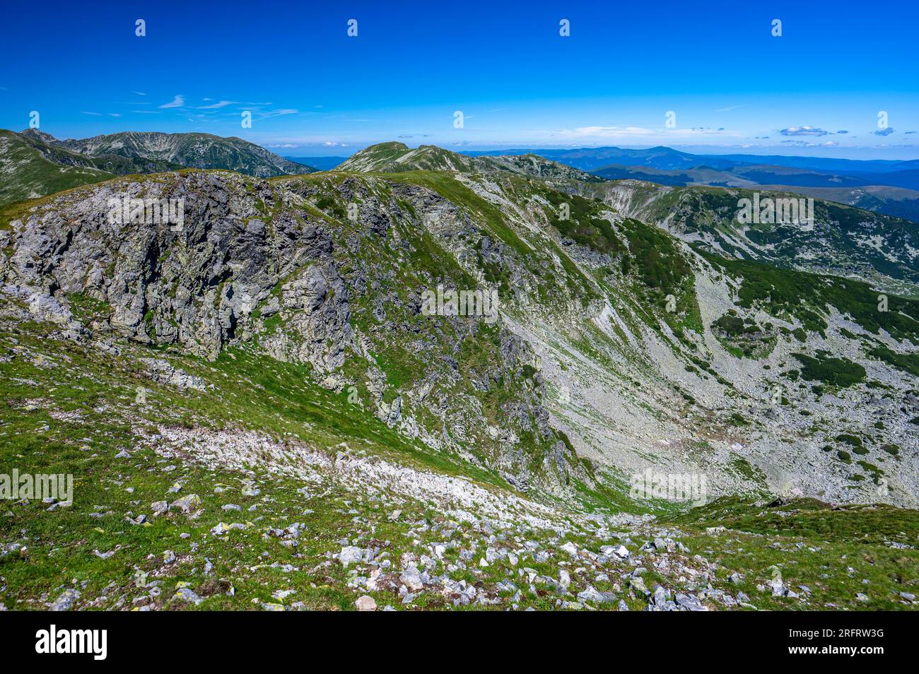Summer day mountain landscape. Green rocky mountains and a blue sky ...