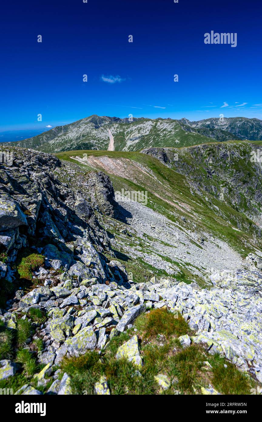 Summer day mountain landscape. Green rocky mountains and a blue sky ...