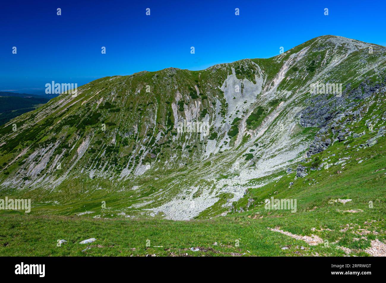Summer day mountain landscape. Green rocky mountains and a blue sky ...