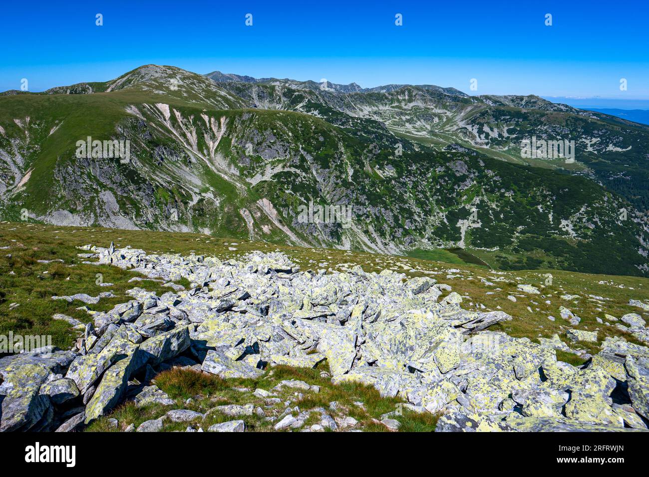 Summer day mountain landscape. Green rocky mountains and a blue sky ...