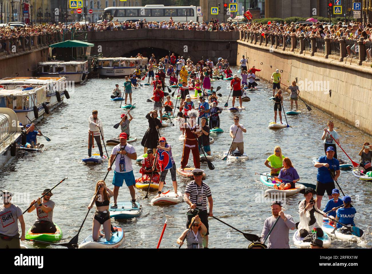 People dressed as various heroes and characters float on surfboards ...