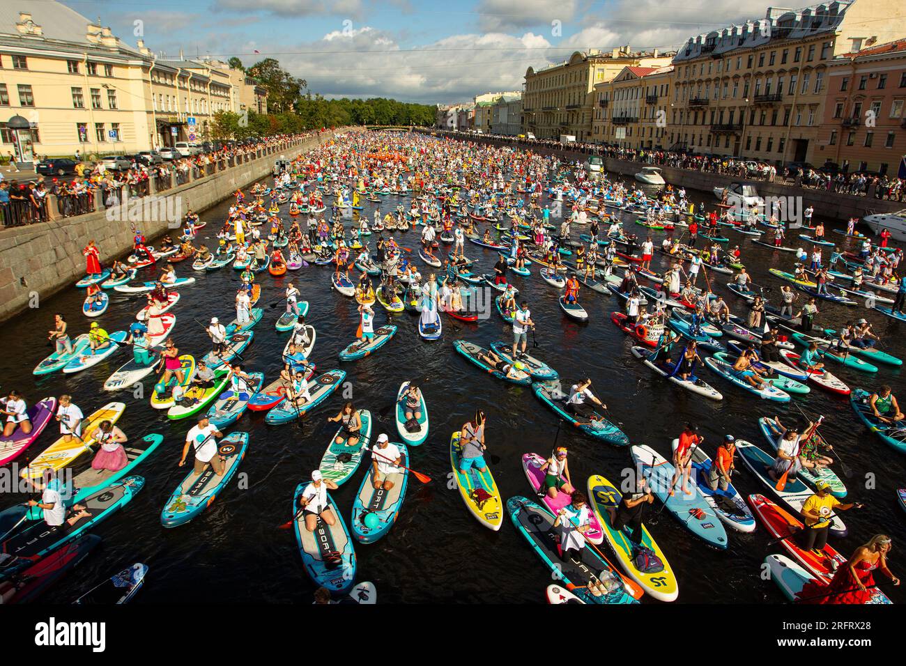People dressed as various heroes and characters float on surfboards ...