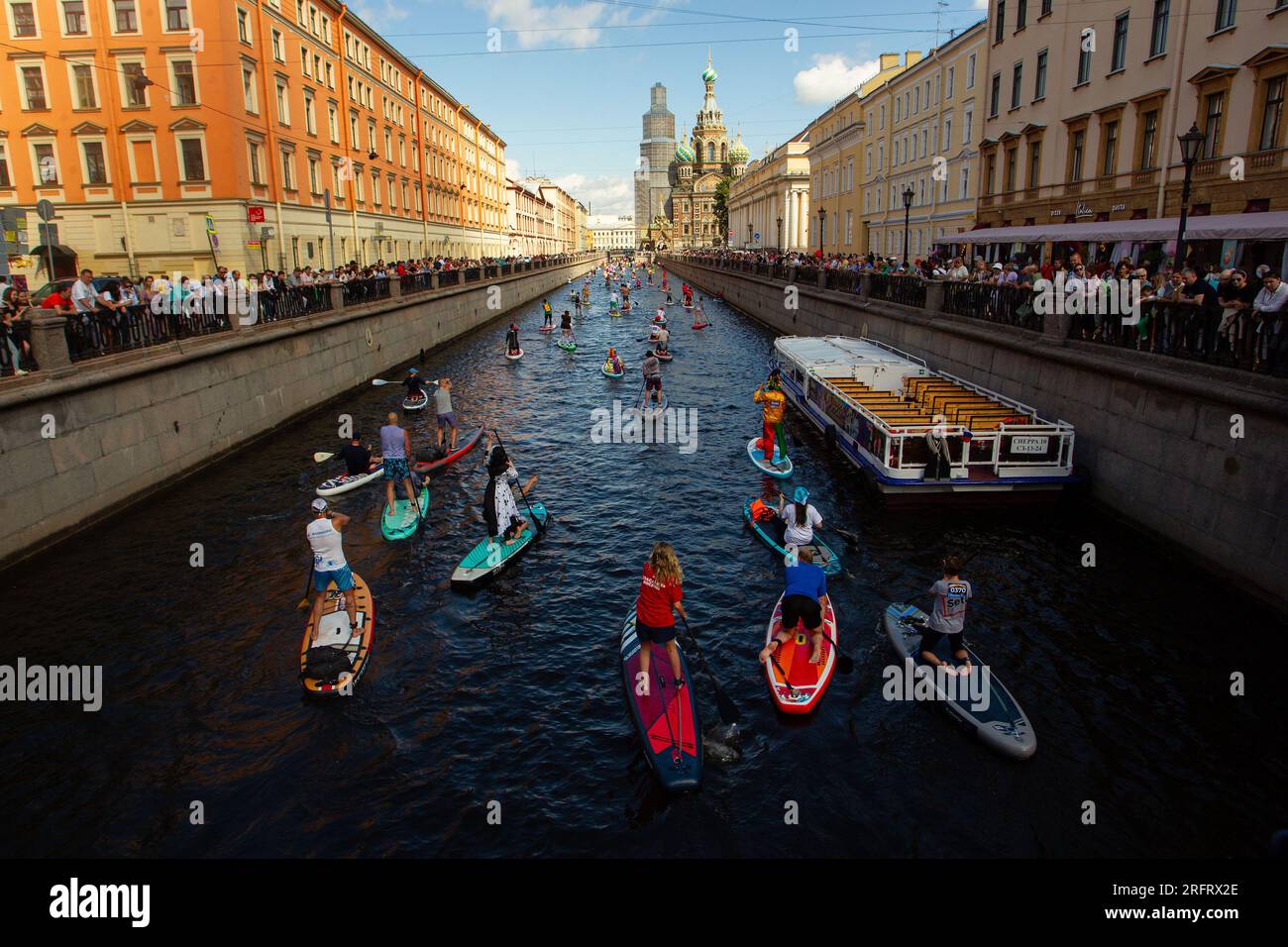 People dressed as various heroes and characters float on surfboards ...