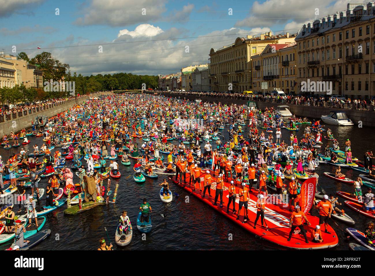 People dressed as various heroes and characters float on surfboards ...