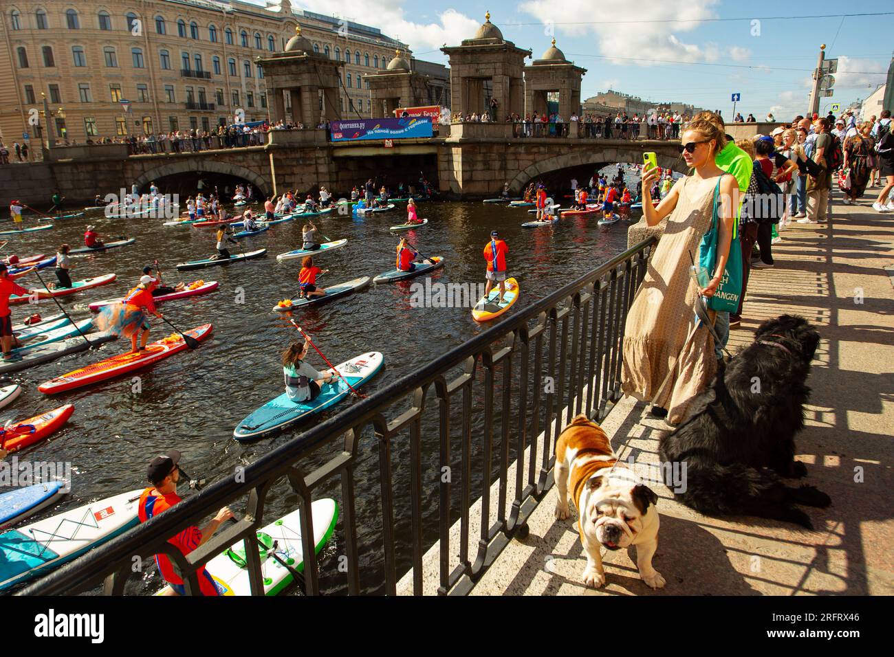 People dressed as various heroes and characters float on surfboards ...