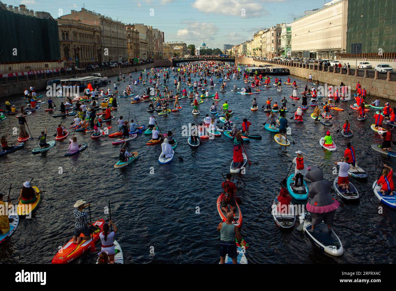 People dressed as various heroes and characters float on surfboards ...