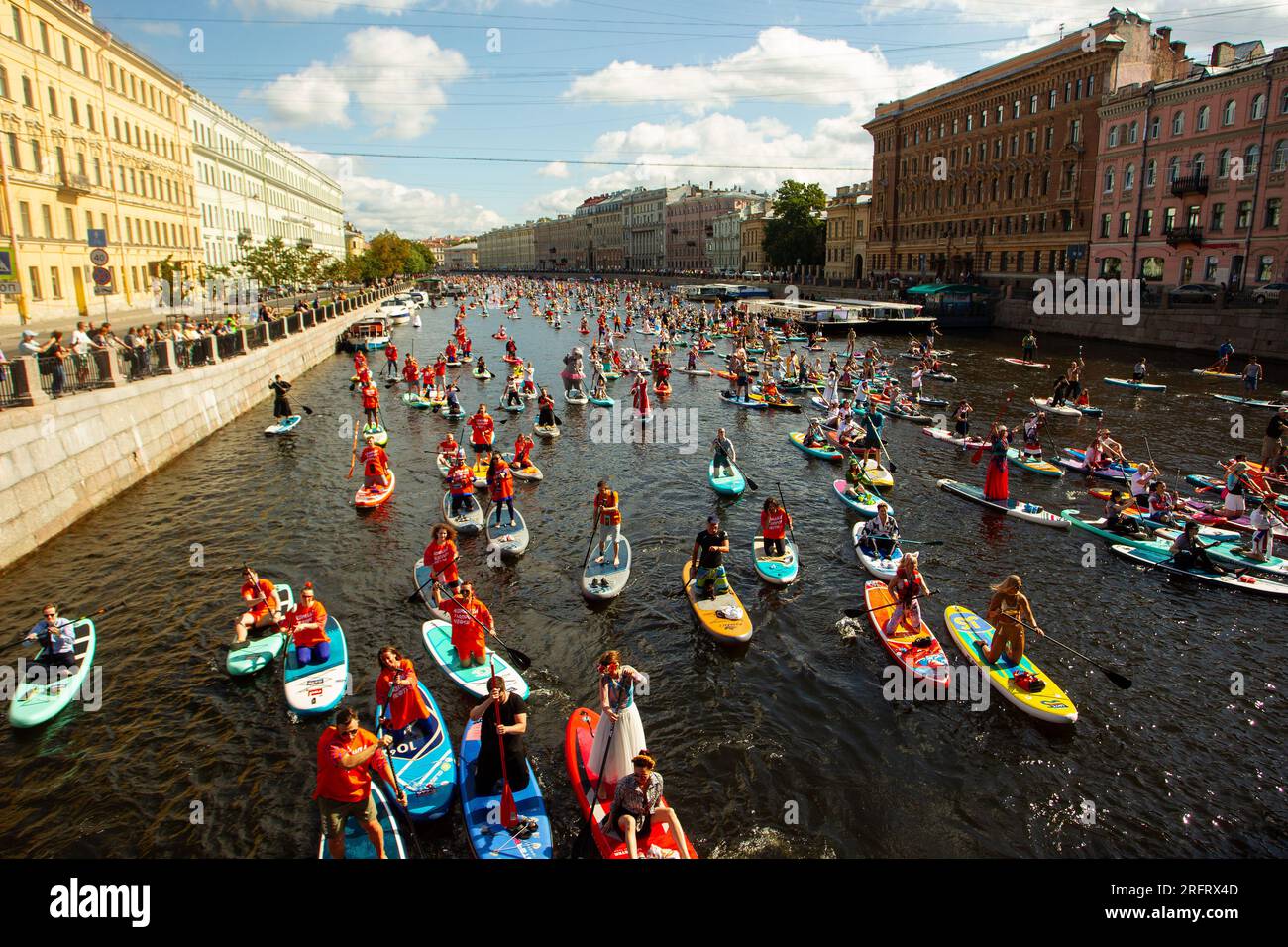 People dressed as various heroes and characters float on surfboards ...