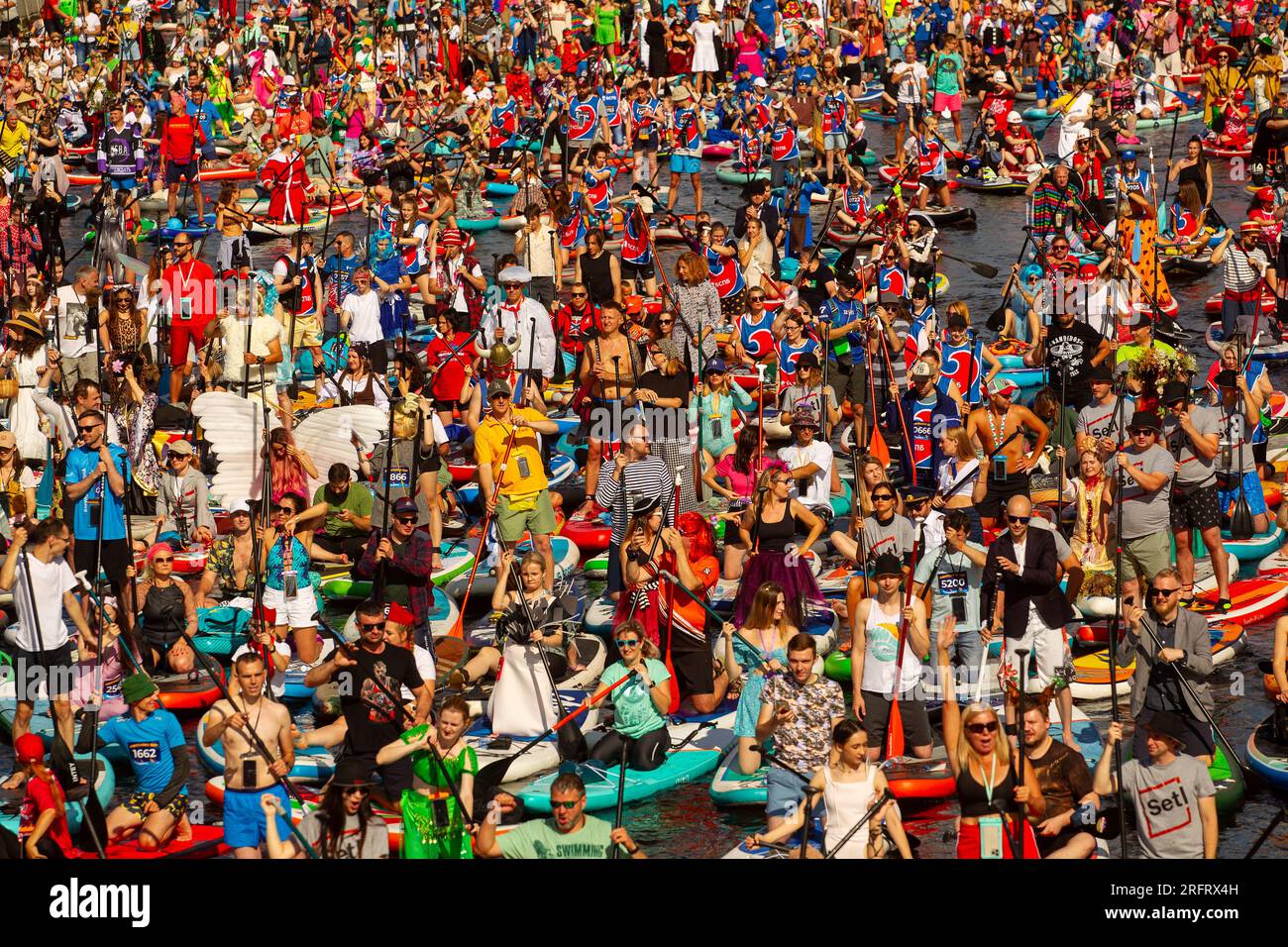 People dressed as various heroes and characters float on surfboards ...