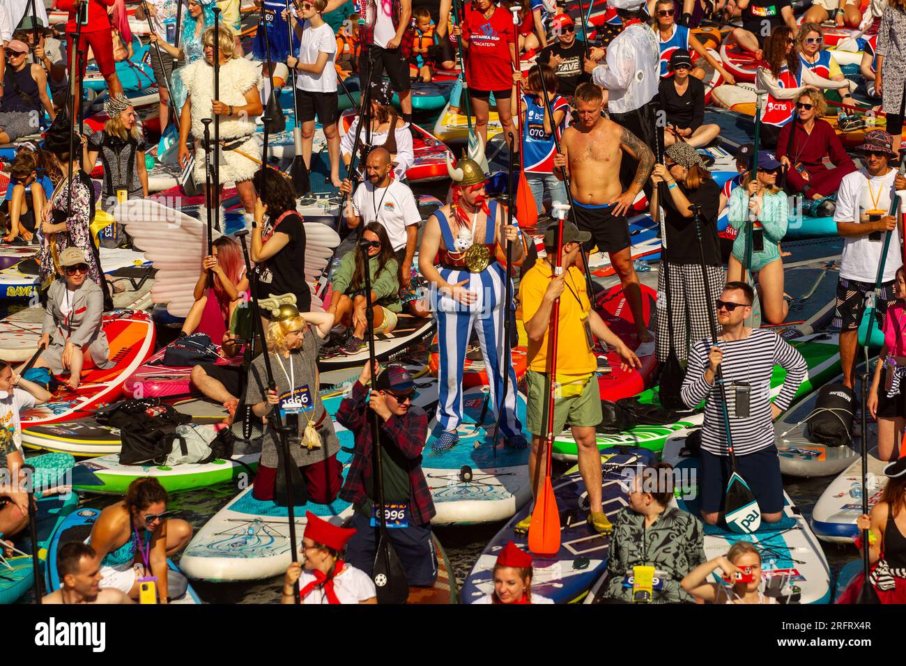 People dressed as various heroes and characters float on surfboards ...