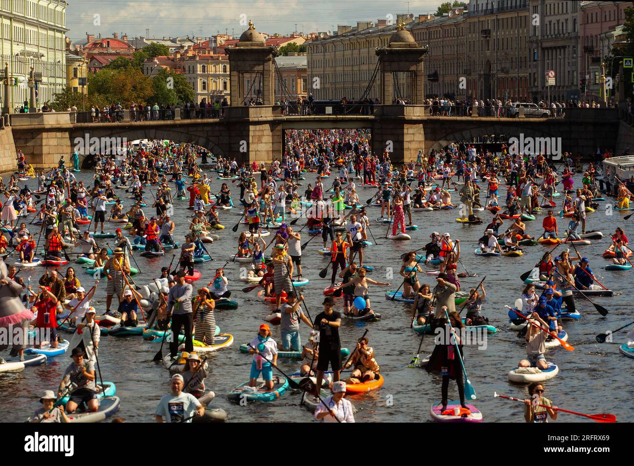 People dressed as various heroes and characters float on surfboards ...