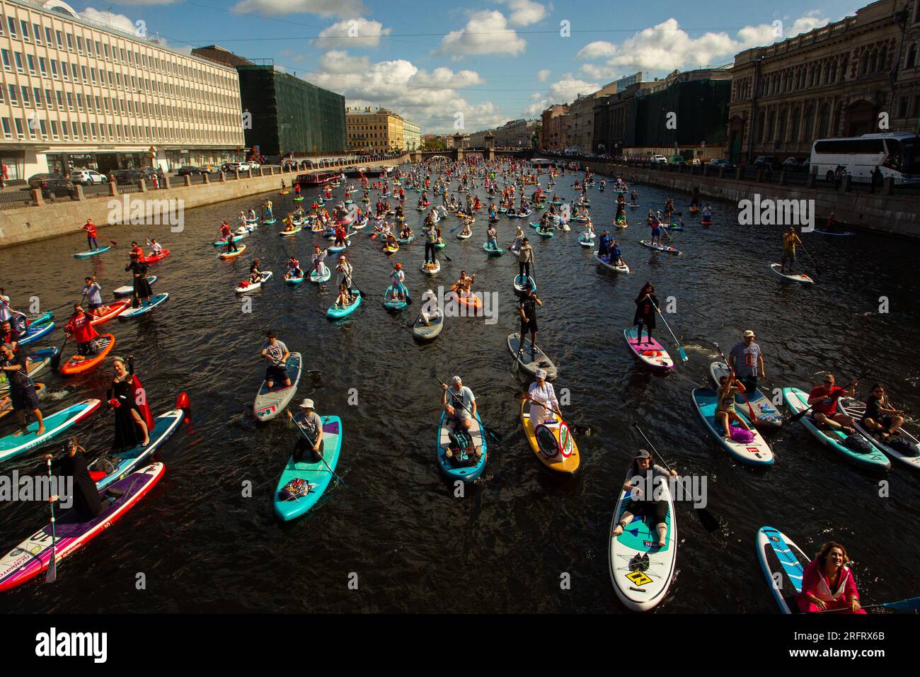 People dressed as various heroes and characters float on surfboards ...