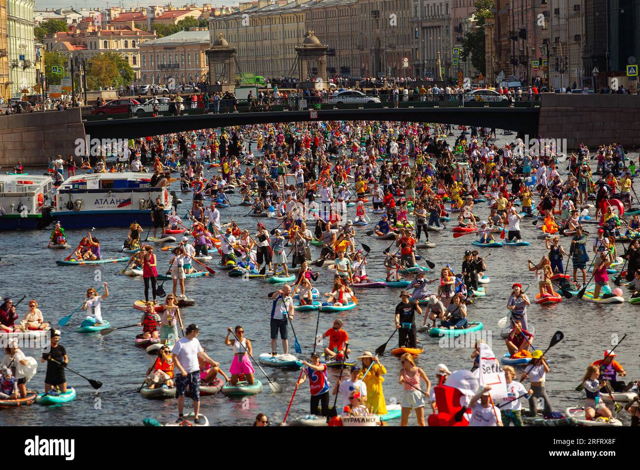People dressed as various heroes and characters float on surfboards ...