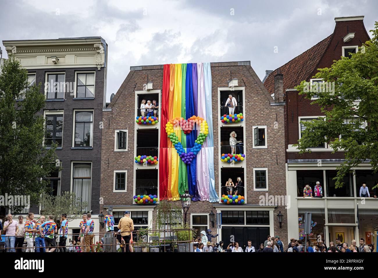 AMSTERDAM - People along the quay during the Canal Parade. The boat ...