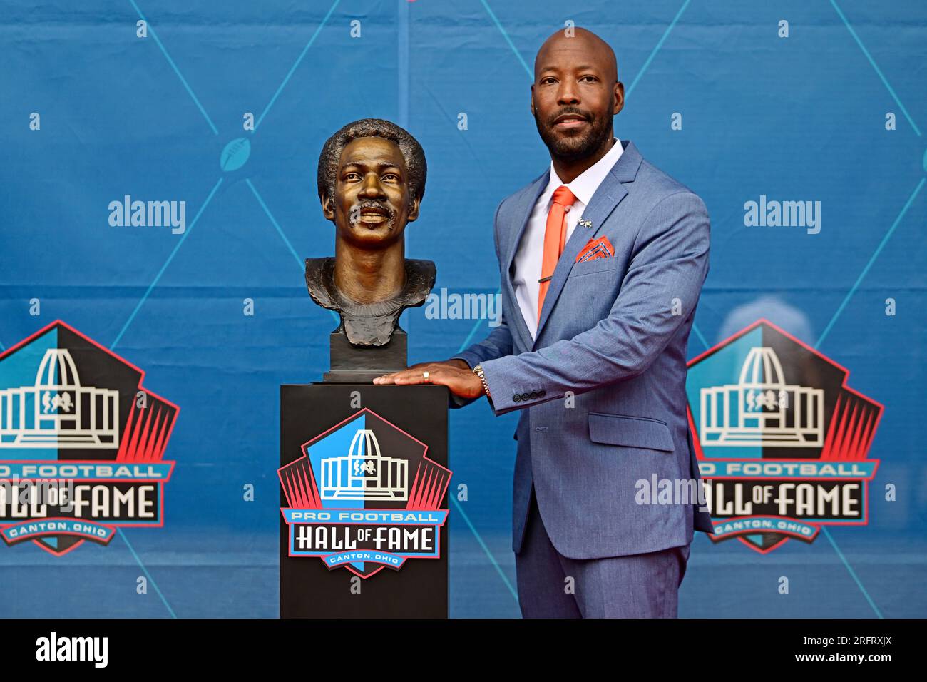 Ken Riley II, son of Ken Riley, poses with his father's bust during his ...