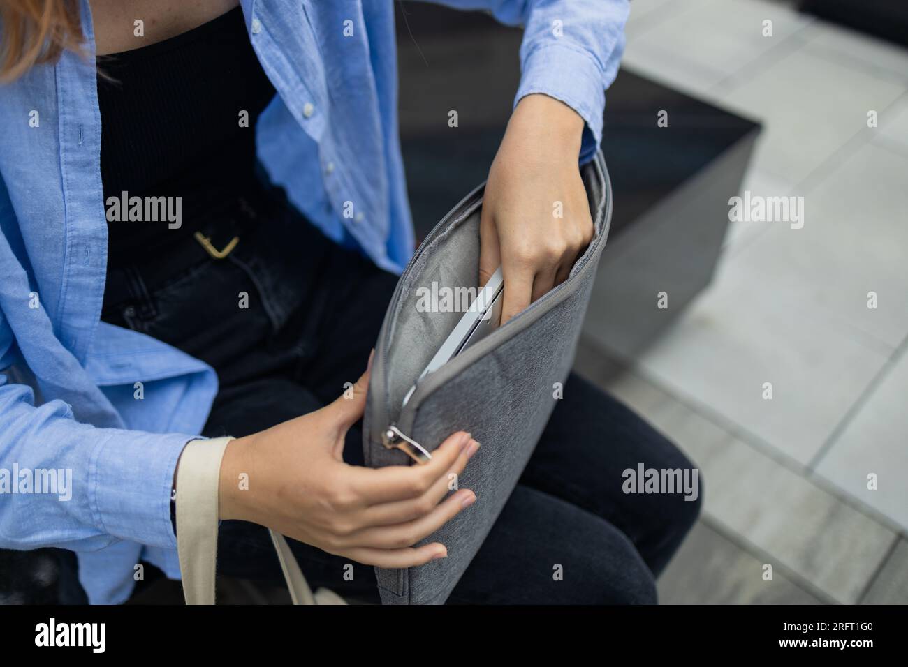 female hands opening fabric backpack putting touchscreen tablet and ...