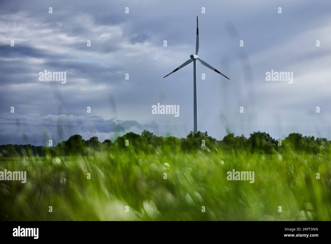 Wind turbines and straw bales lie in a field Stock Photo - Alamy