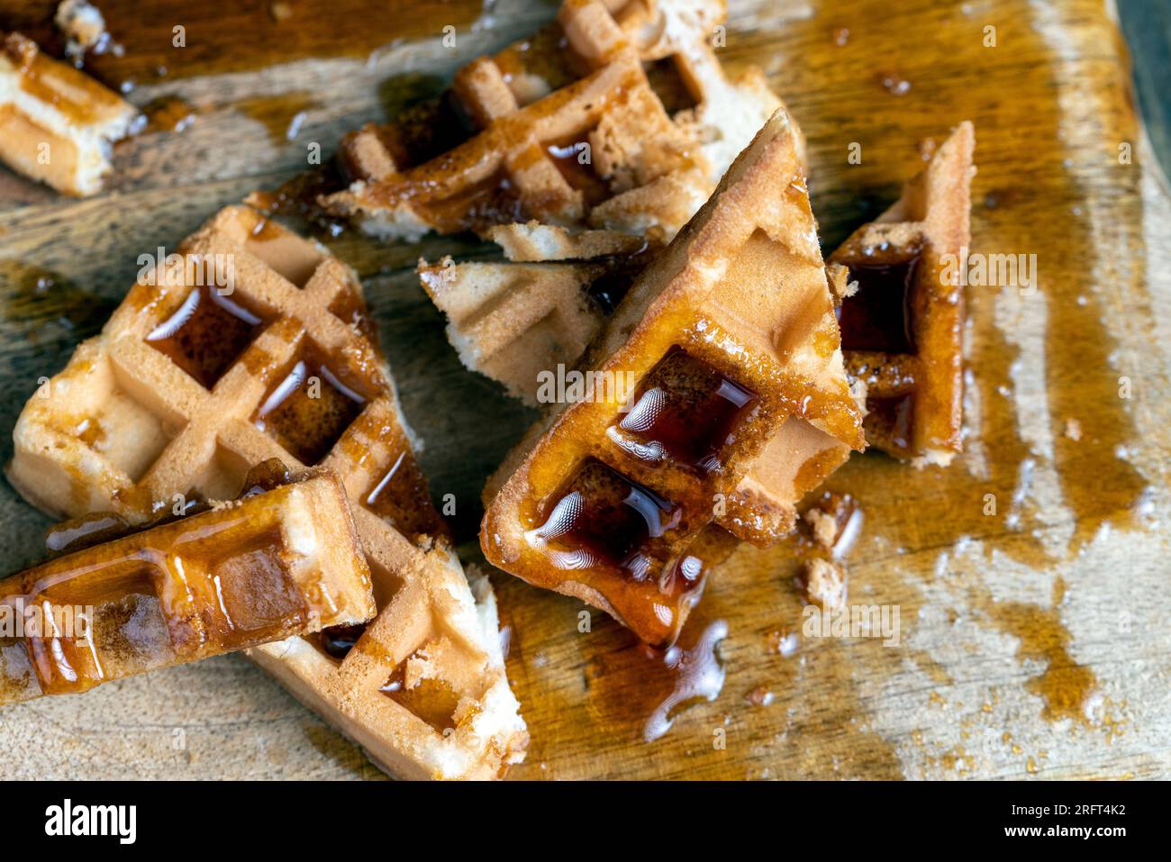 square sweet soft waffles in bee honey , a traditional European dessert ...