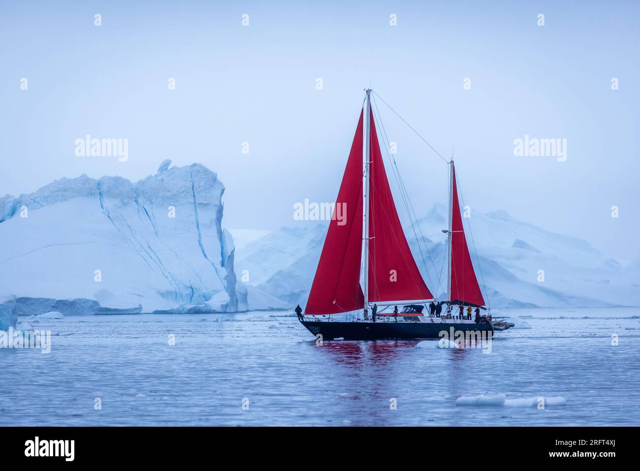 Red sails along Ilulissat Ice Fjord north of the Arctic Circle, Disko ...