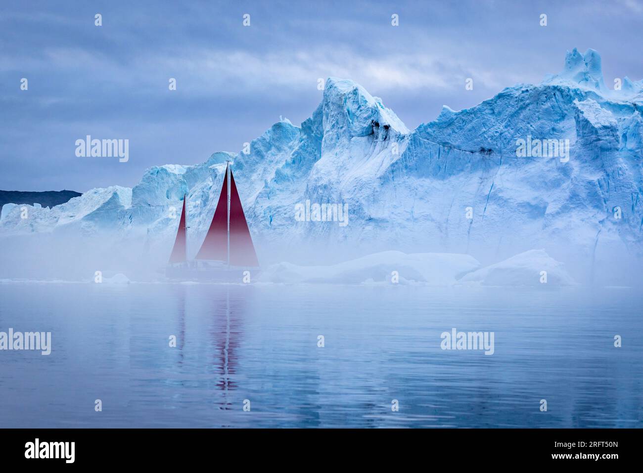 Red sails along Ilulissat Ice Fjord north of the Arctic Circle, Disko ...