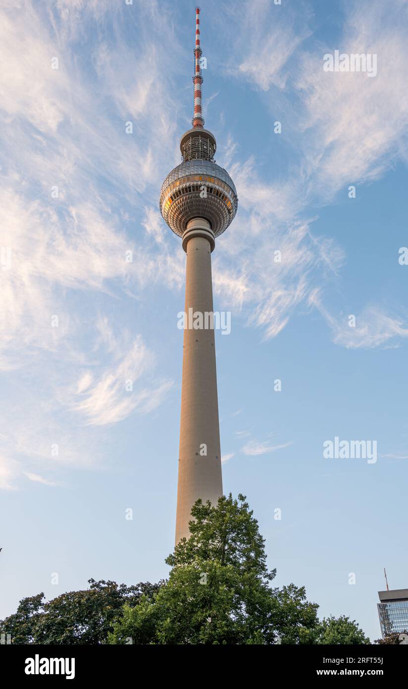 The iconic TV Tower of Berlin shone by the last warm rays of sunlight ...