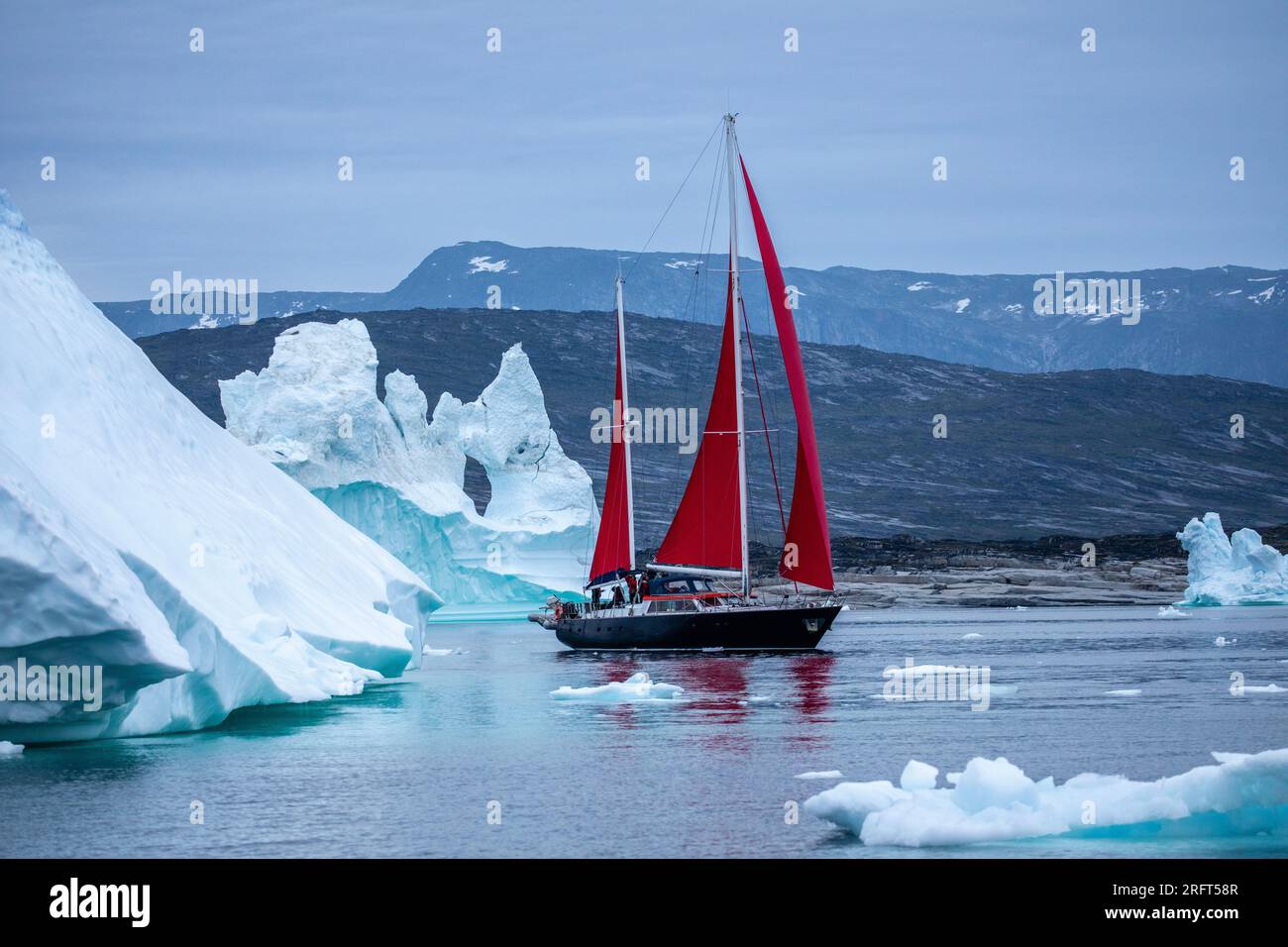 Red sails along Ilulissat Ice Fjord north of the Arctic Circle, Disko ...