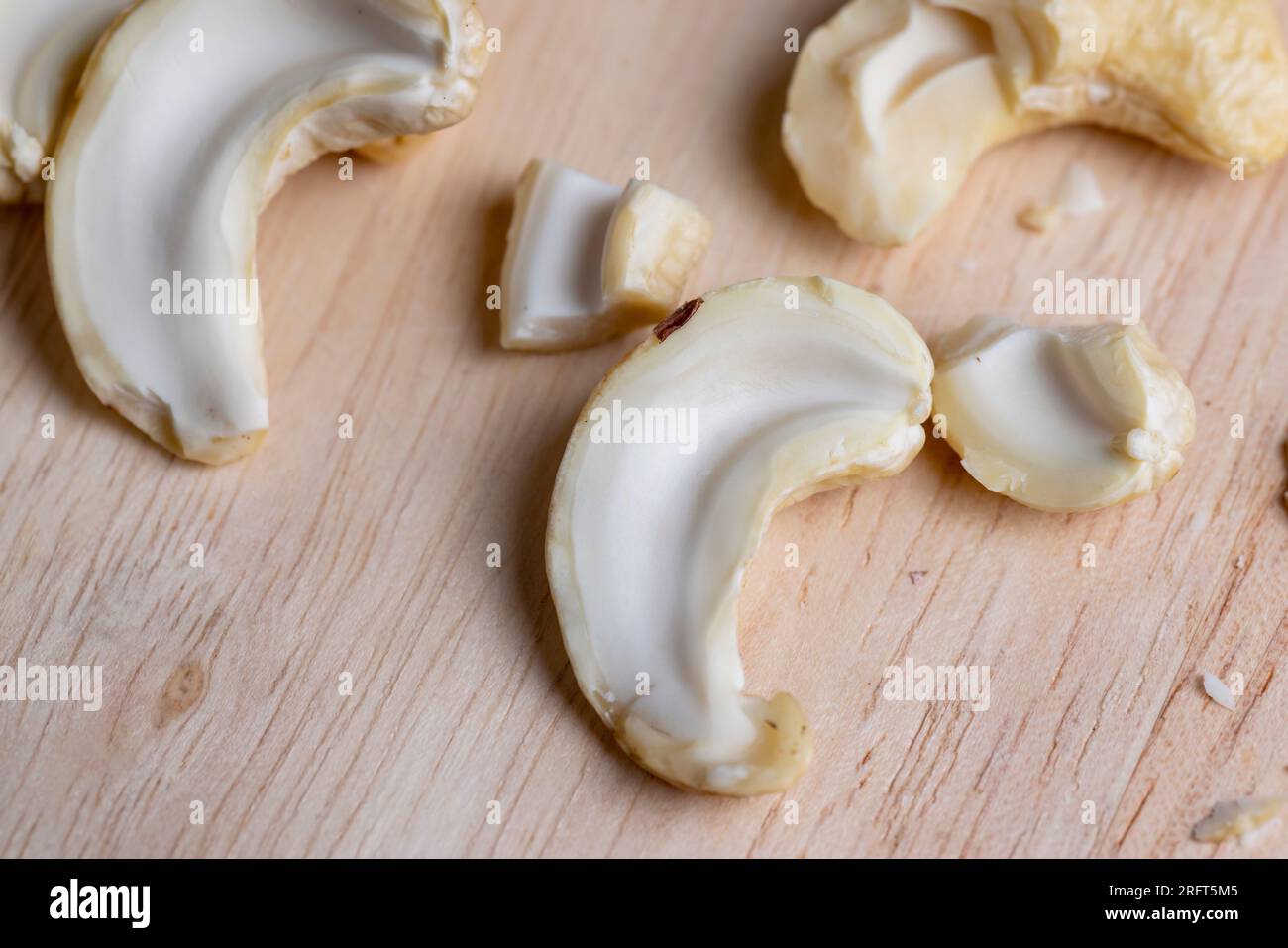 Delicious cashew nuts on a wooden surface, ready to eat and peeled ...
