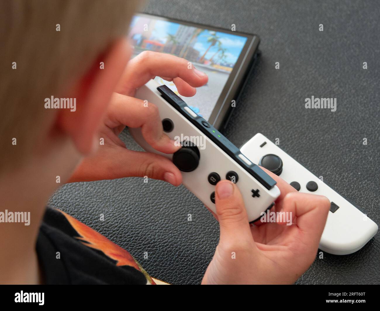 Young boy playing Mario Kart on a new Nintendo Switch console in ...