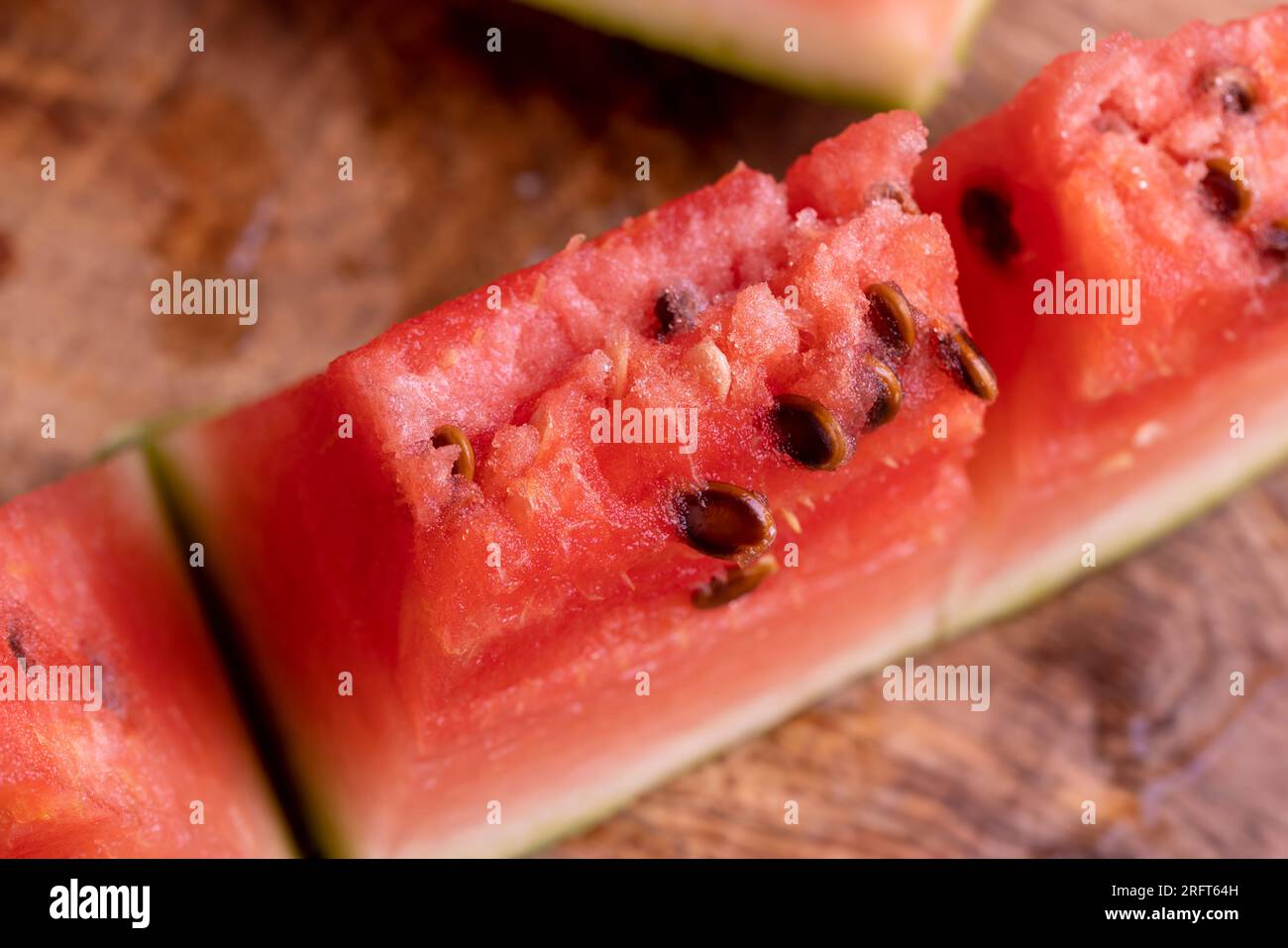 A cut piece of ripe red watermelon with seeds, winter varieties of red ...