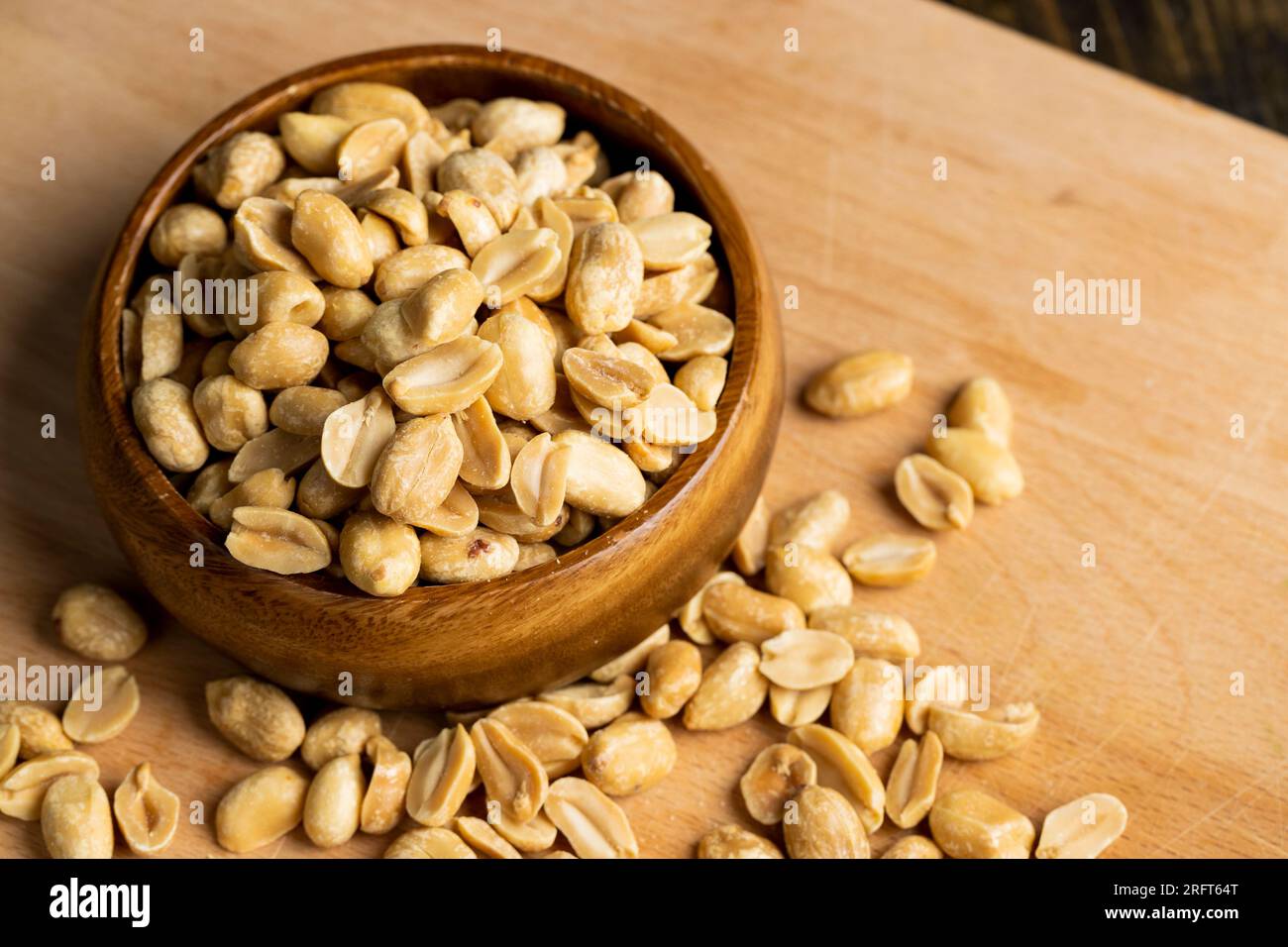 Peeled and roasted peanuts on the table, a pile of whole and half ...
