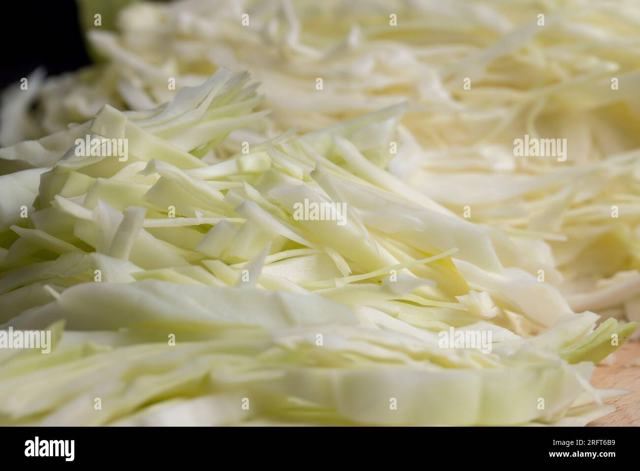 Sliced white cabbage on the table, salad preparation using fresh white ...