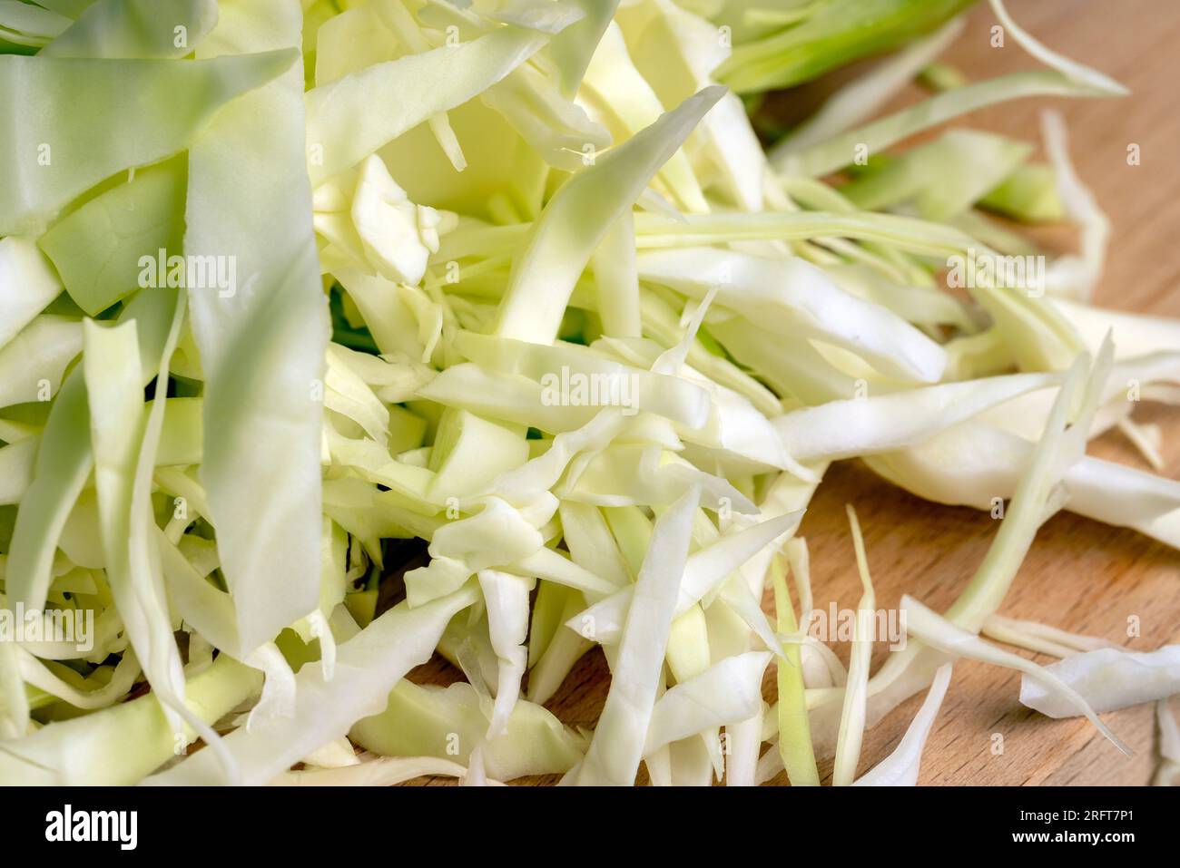 Sliced white cabbage on the table, salad preparation using fresh white ...