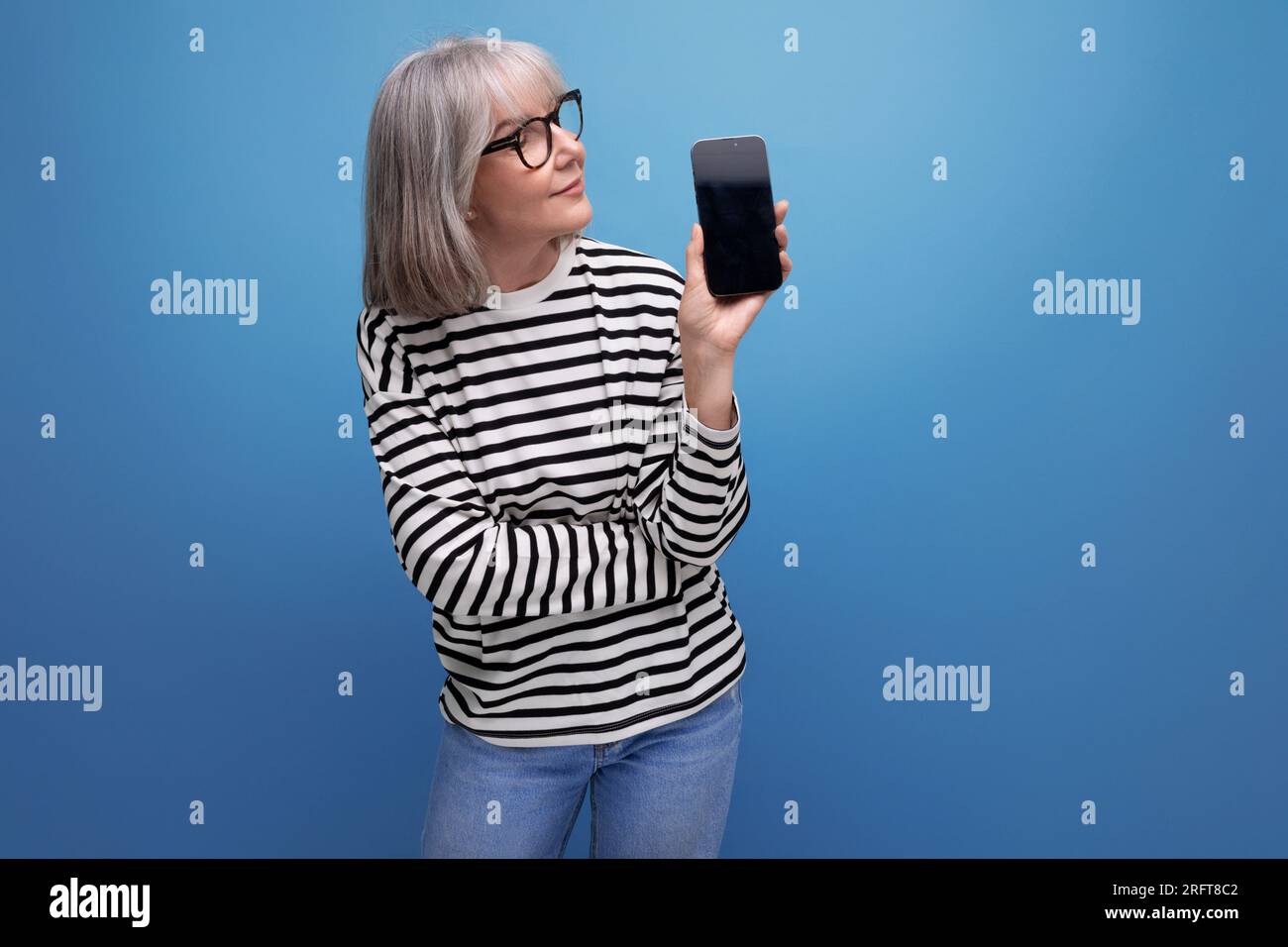 middle aged business woman surfs the internet using smartphone on ...