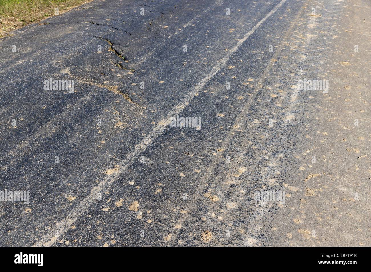Details of a road polluted with sand and debris from fields, sand and ...