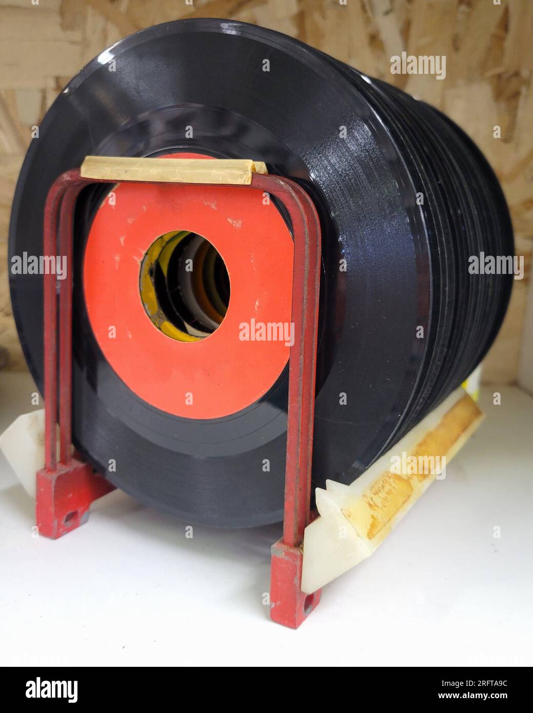 A collection of vintage 45 RPM (45's) records, displayed in a metal ...