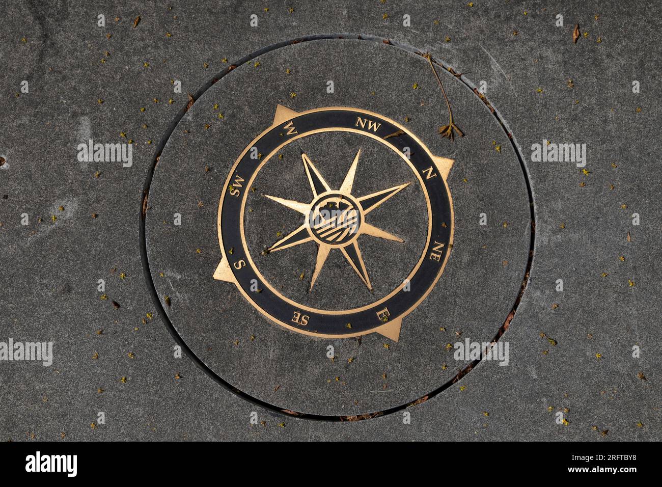 A manhole cover, locally known as a hatch cover, is embellished with a ...