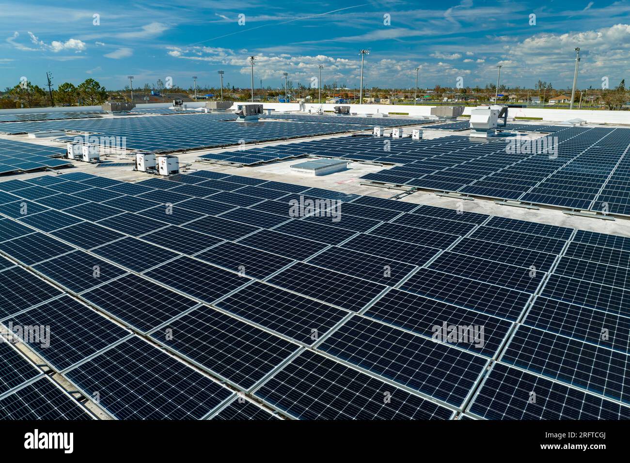 Aerial view of blue photovoltaic solar panels mounted on industrial ...