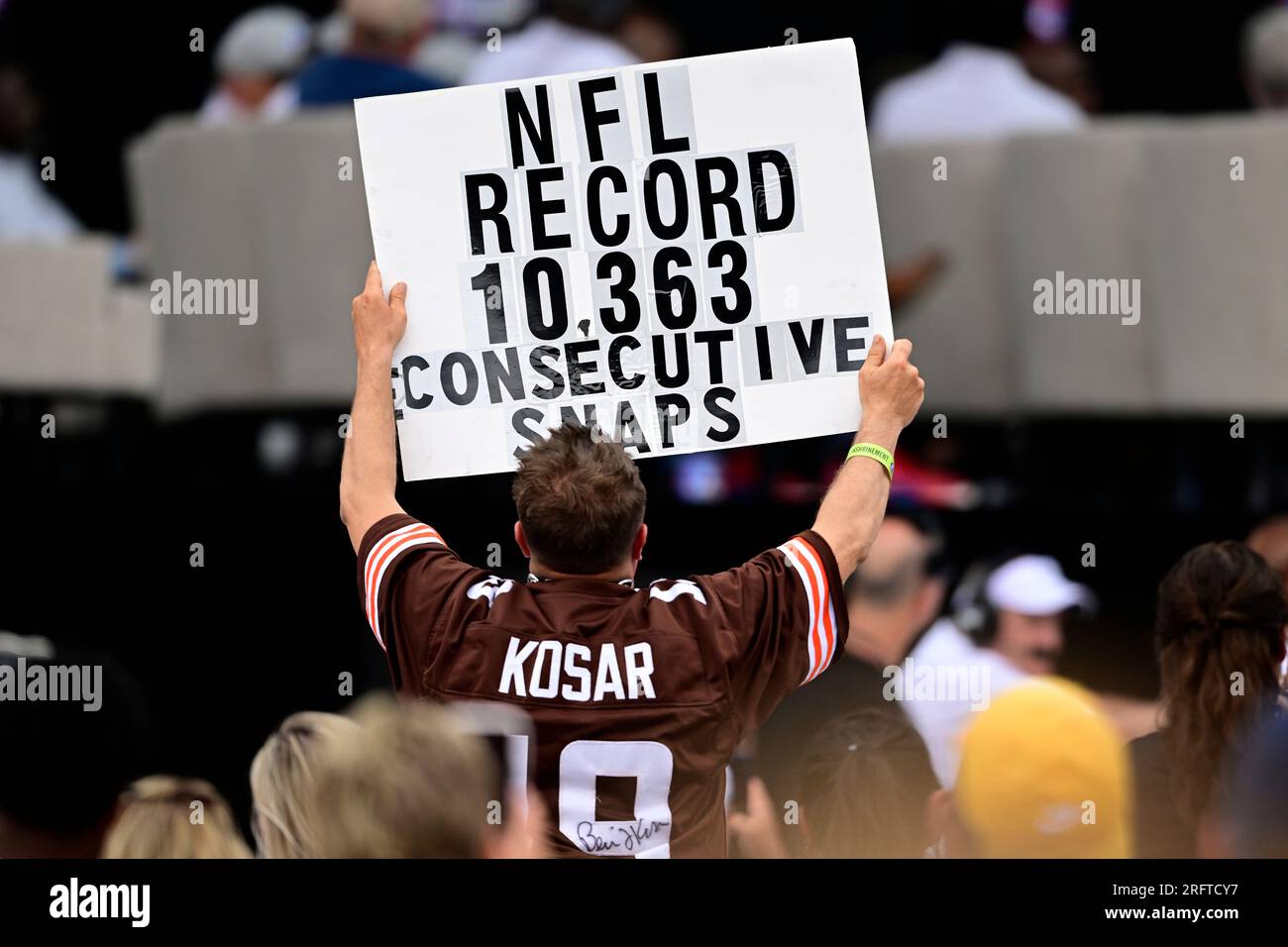 A fan holds a sign honoring a NFL record held by former NFL player Joe ...