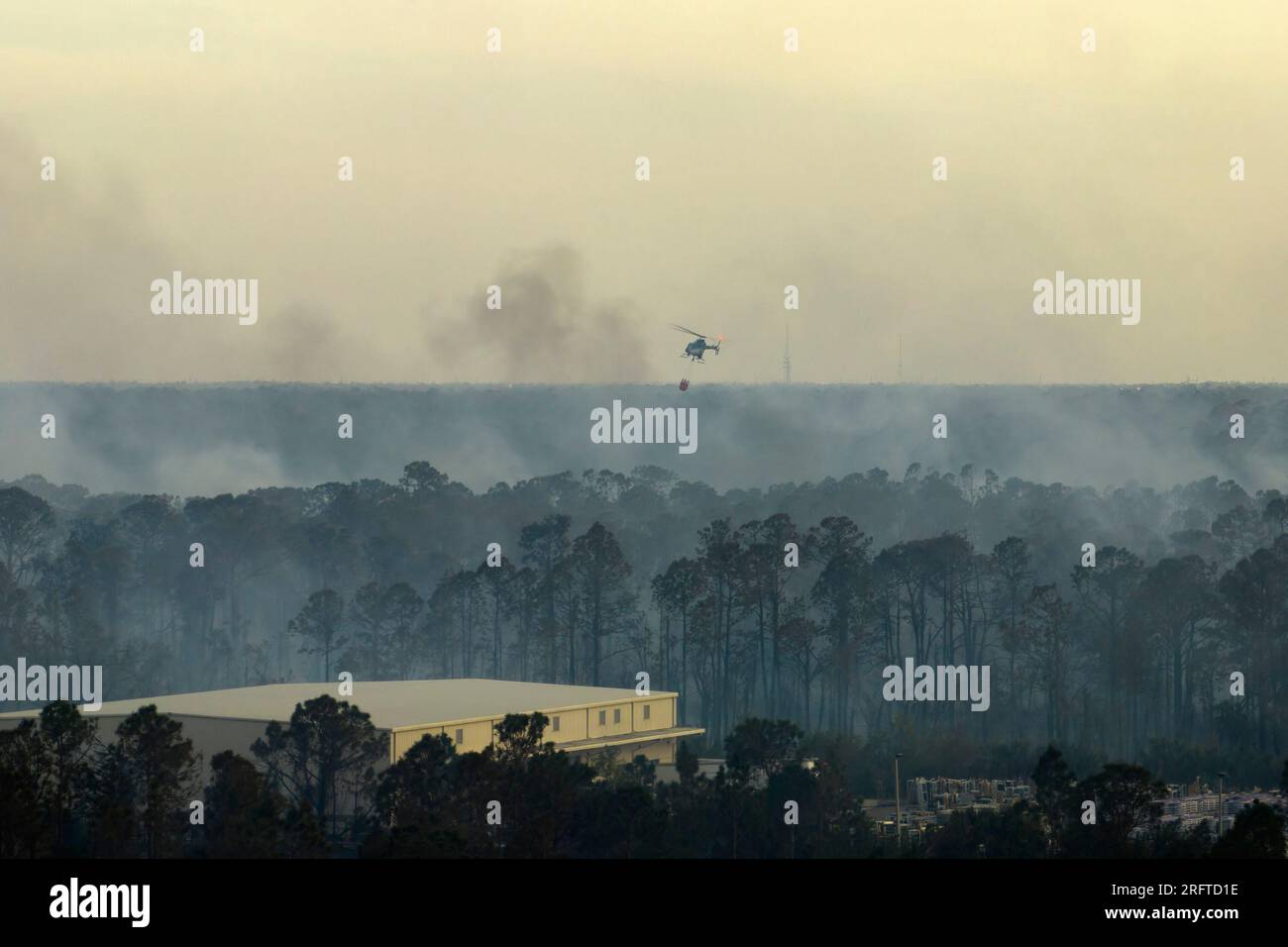 Aerial view of fire department helicopter extinguishing wildfire ...